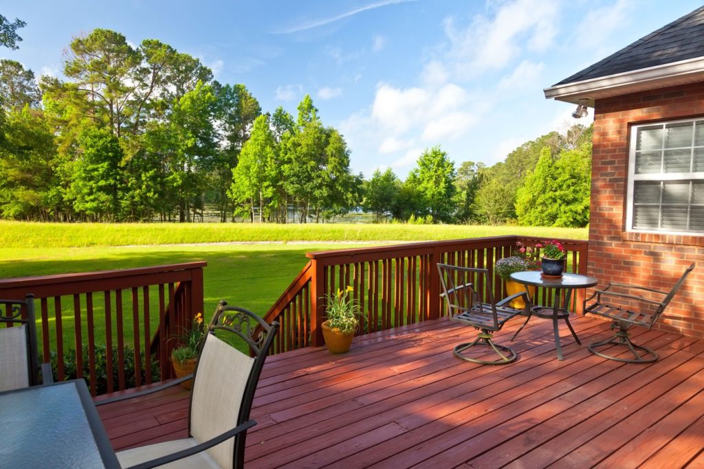 20933342 - residential backyard deck overlooking lawn and lake | Beam ...